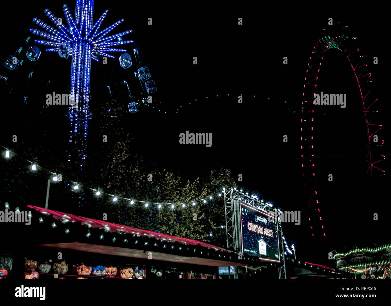 night time at christmas fun fair on south bank London, carousel and ...