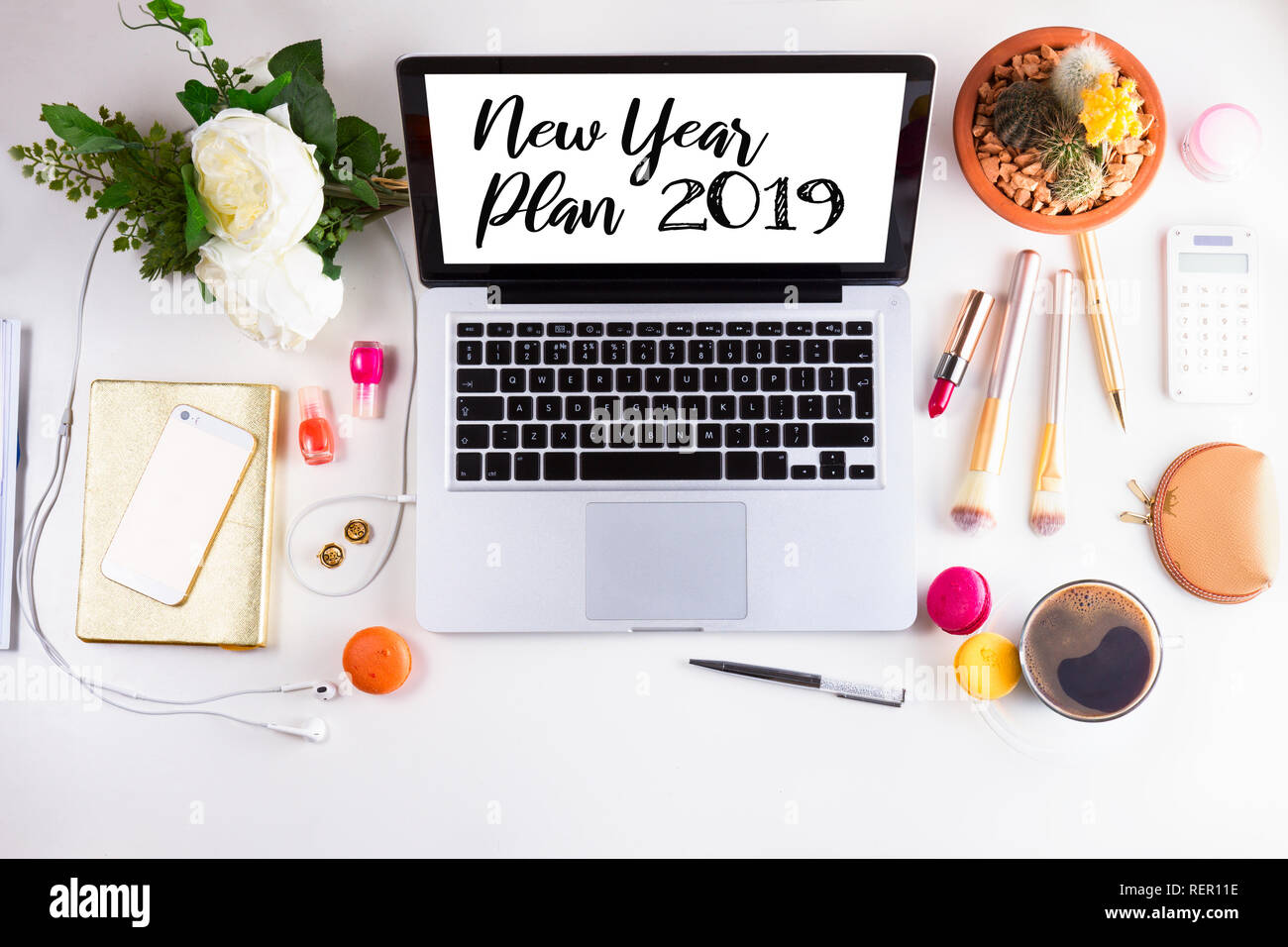 2019 new years plan with modern laptop, coffee and flowers, top view ...