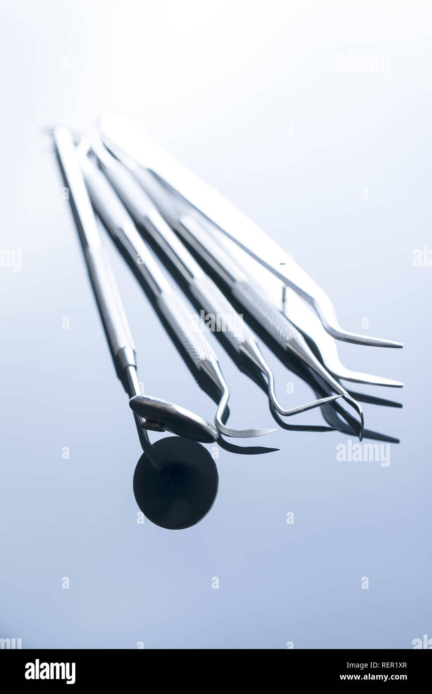 Dental instruments. Dentists tools on mirror background Stock Photo - Alamy