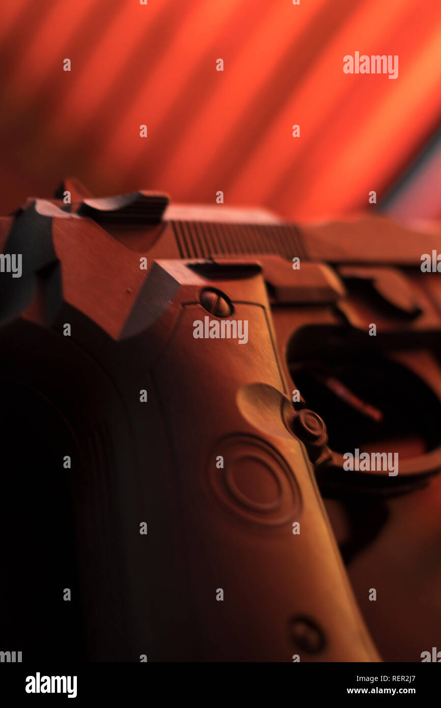 Pistol automatic handgun weapon on table in hotel bedroom in ...