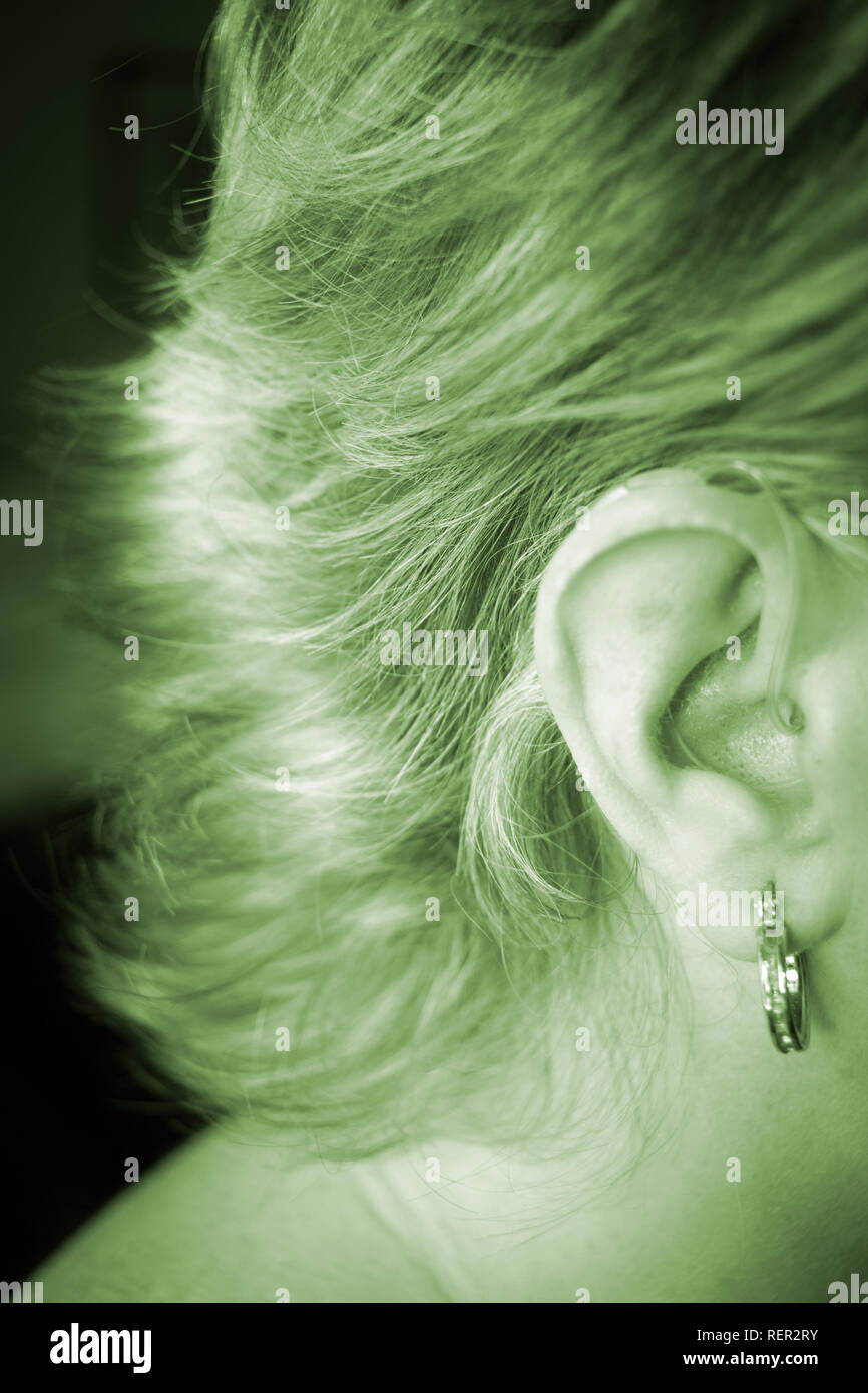 Deaf lady with modern technology digital hearing aid in her ear Stock ...
