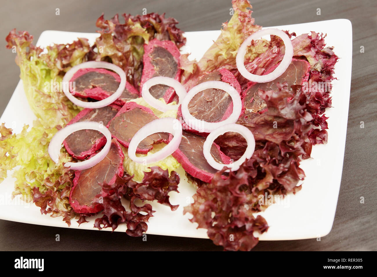 basturma with spices and onions on salad leaves Stock Photo - Alamy