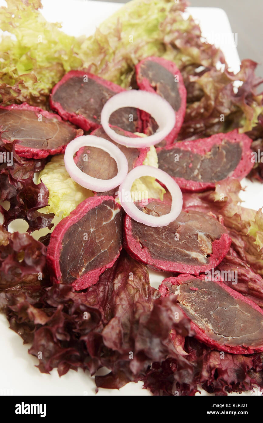 basturma with spices and onions on salad leaves Stock Photo - Alamy