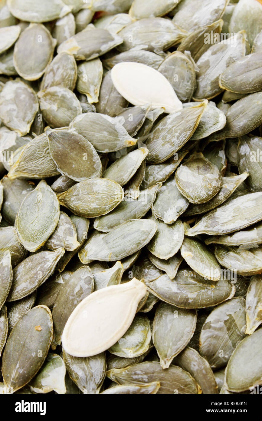 Pumpkin seeds, sort without peel, background Stock Photo - Alamy