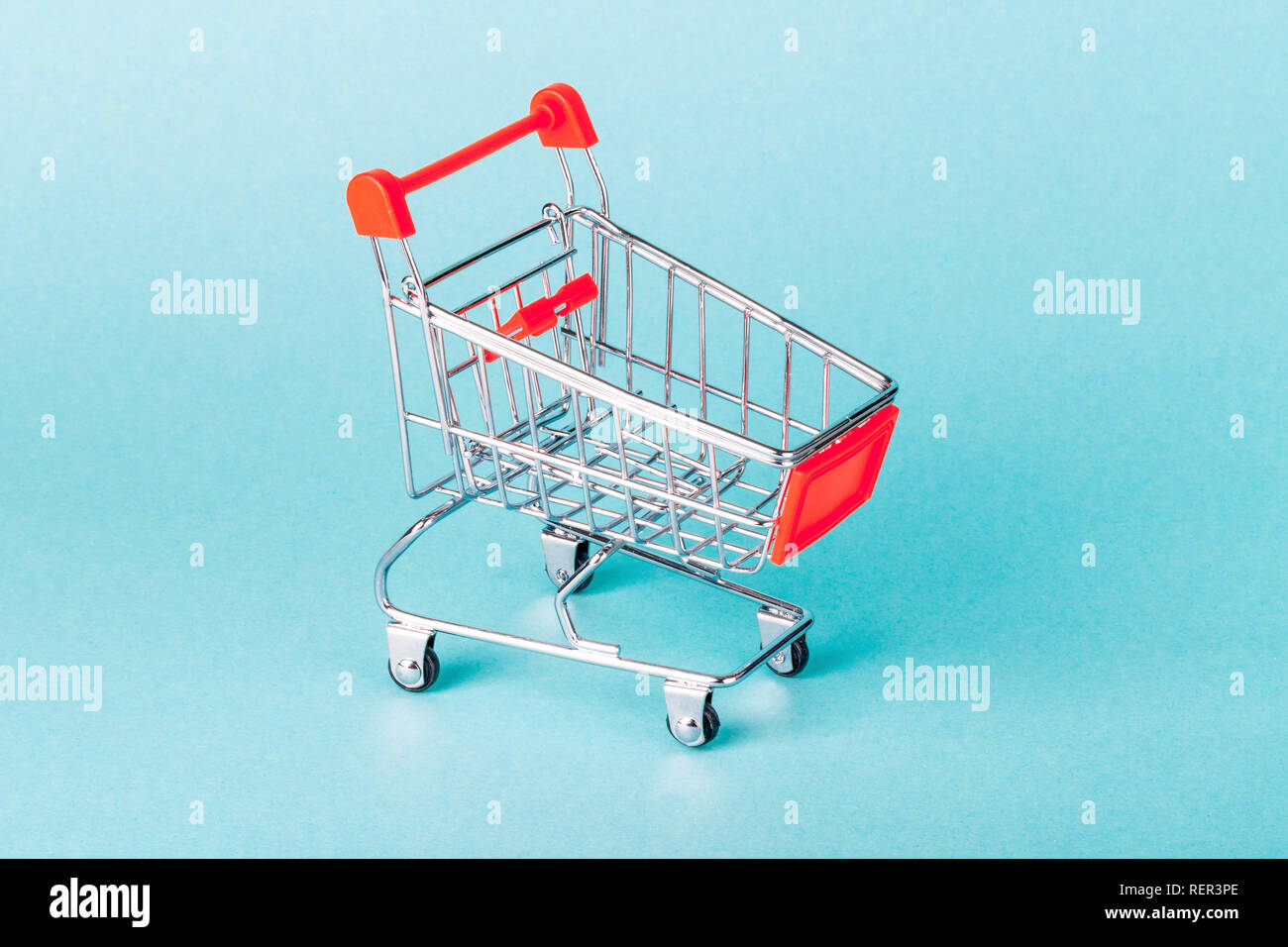 image of side view empty supermarket shopping cart on blue background ...