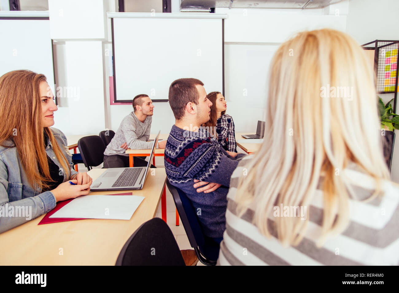 Young students are listening carefully their professor Stock Photo - Alamy