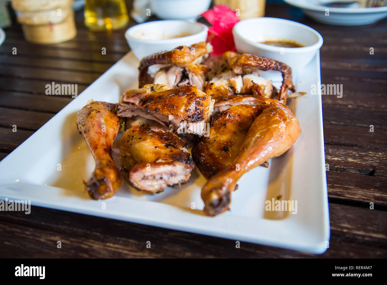 Grilled Chicken on the table in the restaurant Stock Photo - Alamy