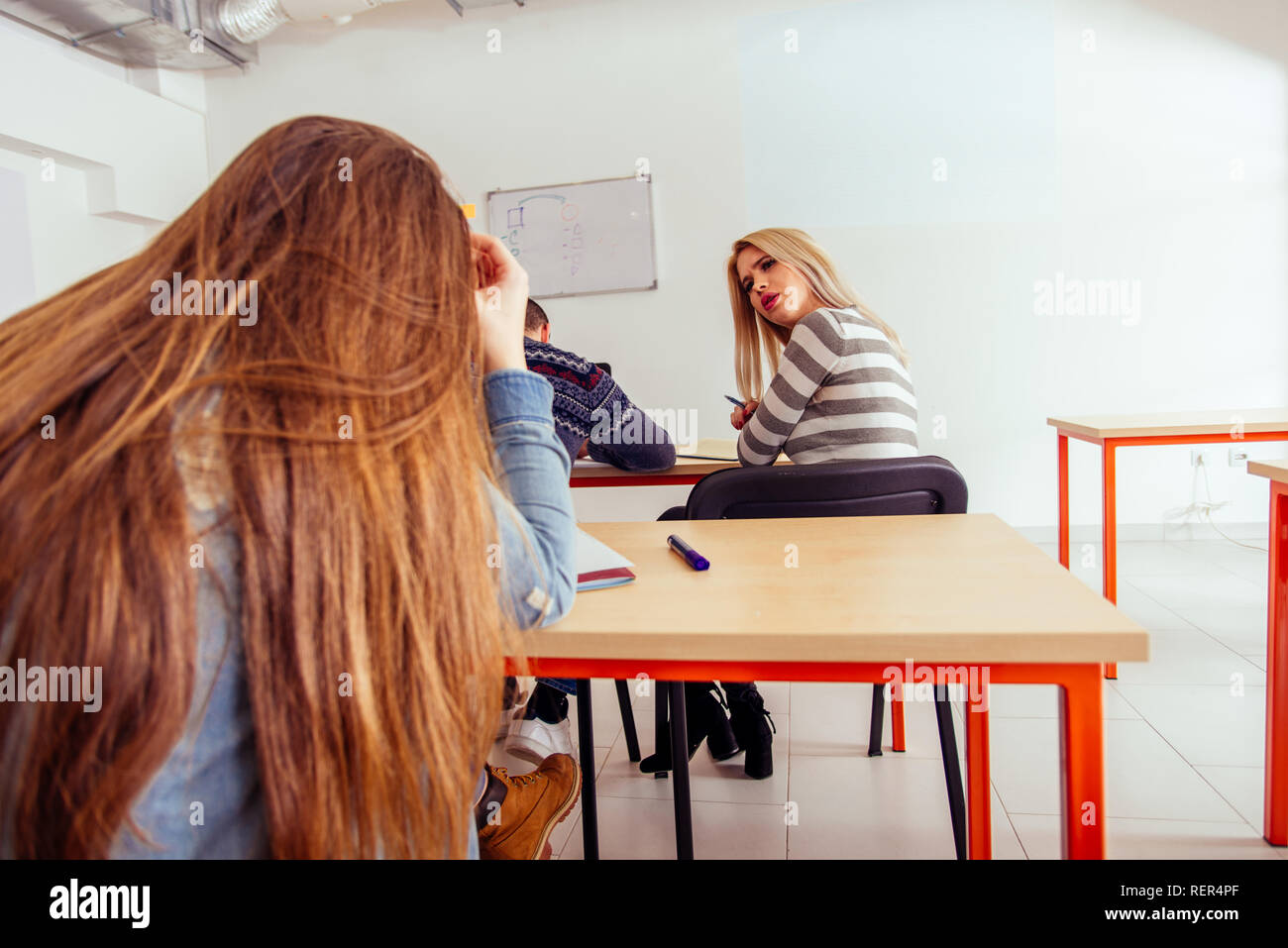 Group of students are in school, they are studying and looking at their ...