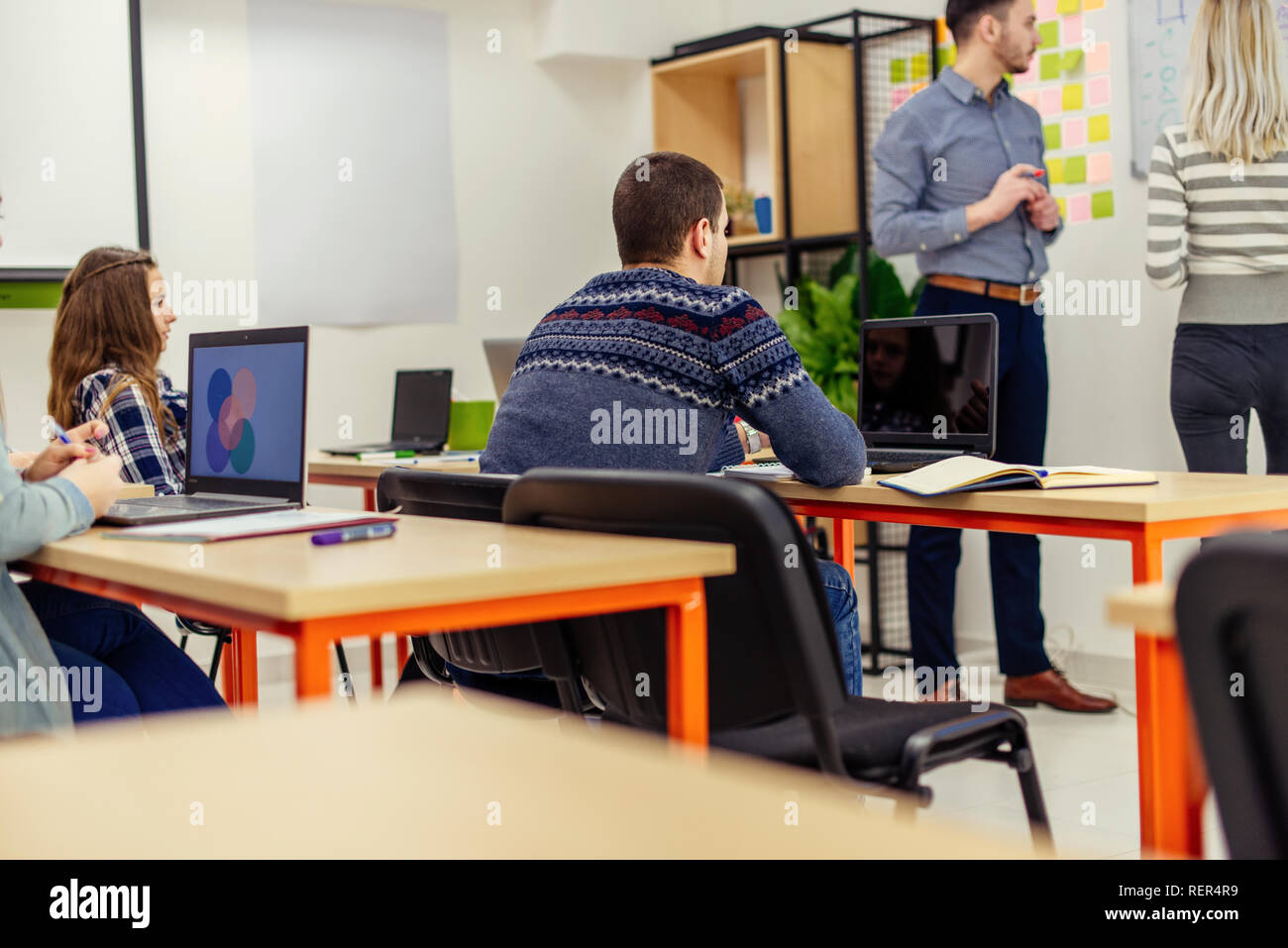 Young students are in classroom, they are looking interested at their ...
