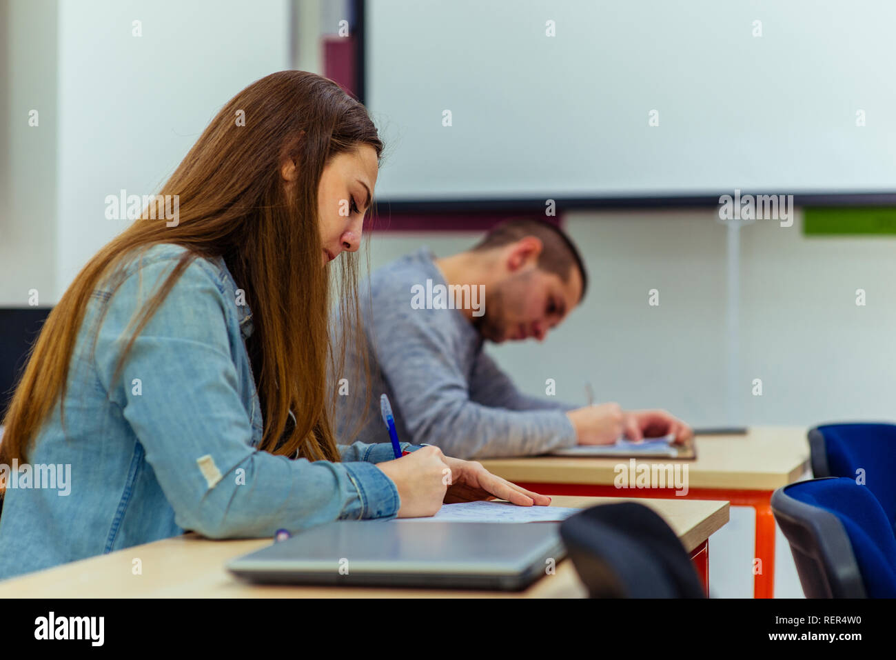 Knowledge testing of young students in classroom Stock Photo - Alamy