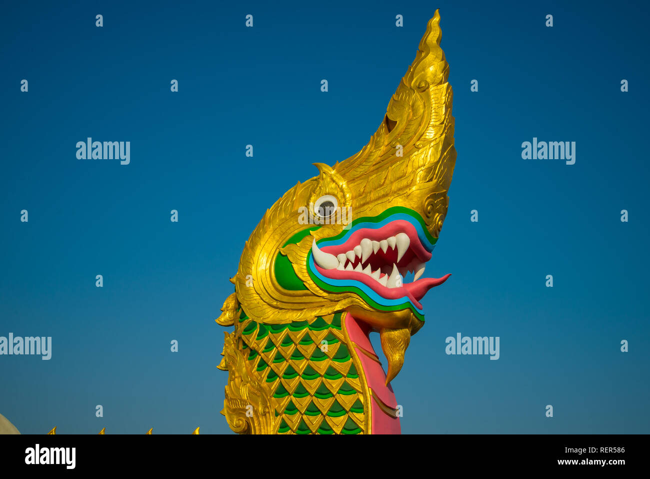 Large golden naga on the blue sky background Stock Photo - Alamy