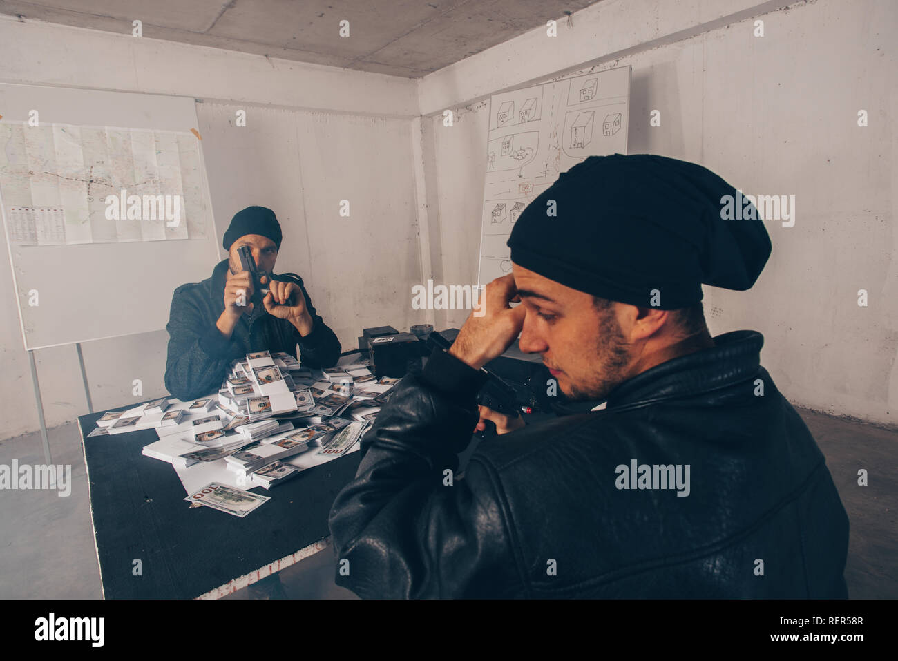 Gangsters are counting money in a smoky room while holding weapon Stock ...