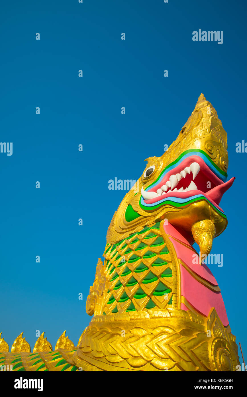 Large golden naga on the blue sky background Stock Photo - Alamy