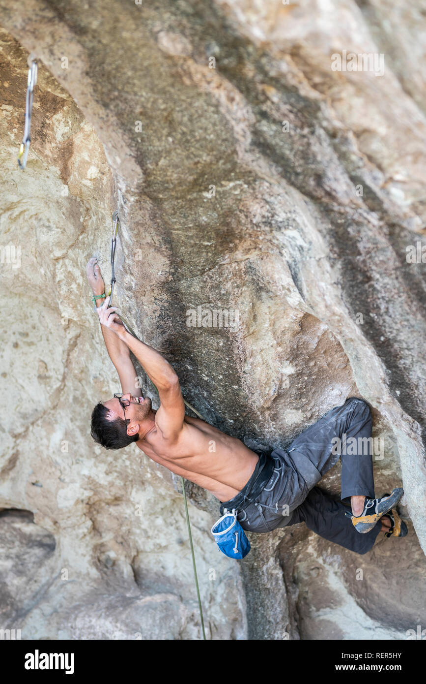 Practicing rock climbing extreme sport inside Andes mountains at a rock ...