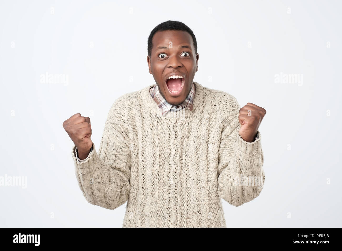 Portrait of african young handsome man surprised with news he got Stock ...