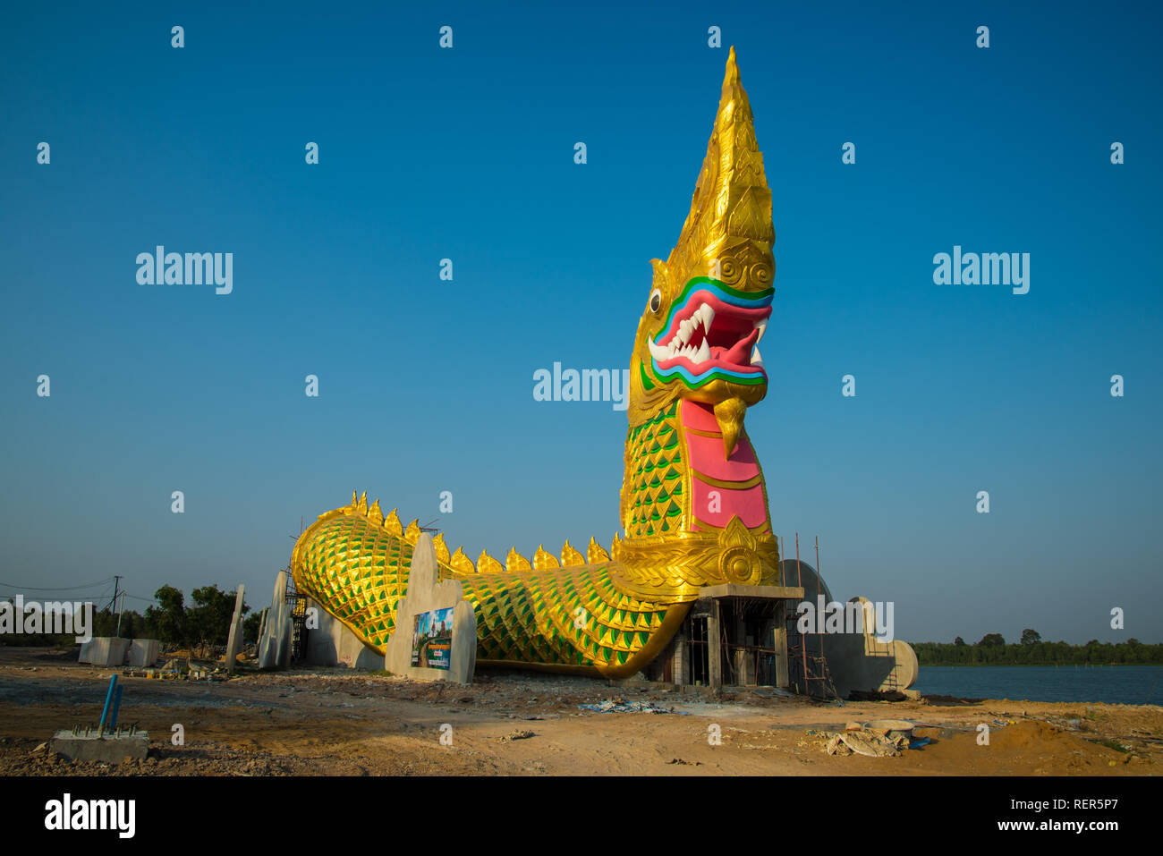 Large golden naga on the blue sky background Stock Photo - Alamy