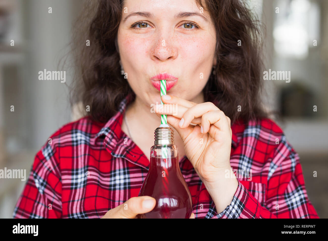 Health, food, diet and people concept - young woman drinking natural ...