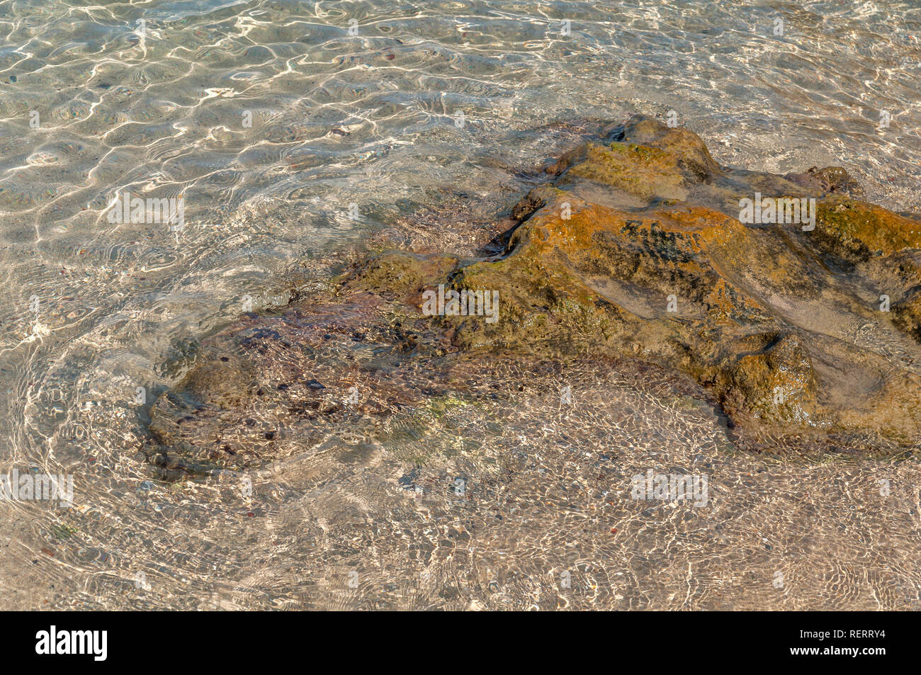 Big moss stone with sea water wave Stock Photo - Alamy