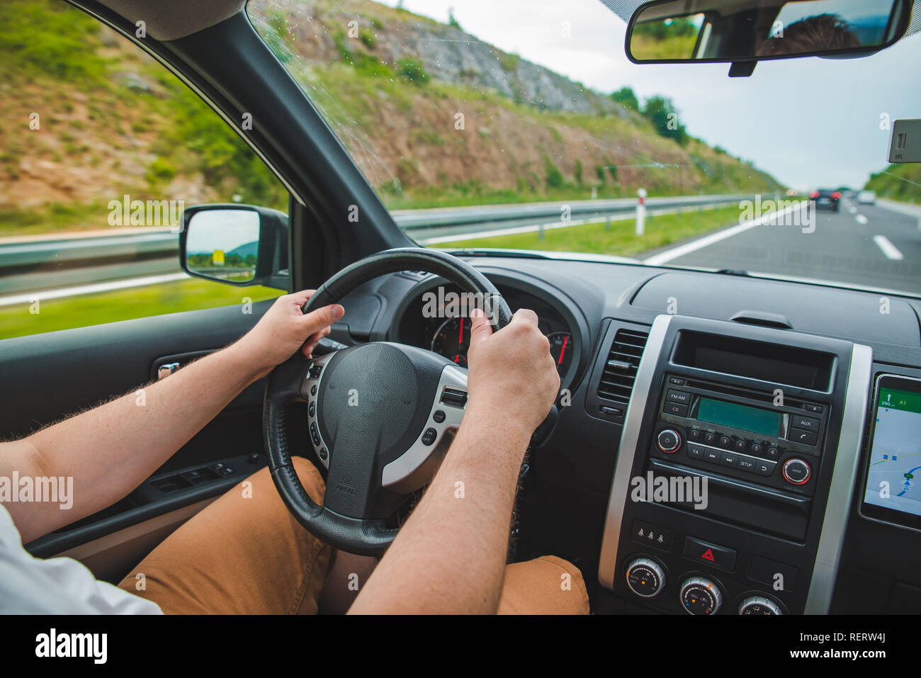 man driving car by speedway. road trip Stock Photo - Alamy