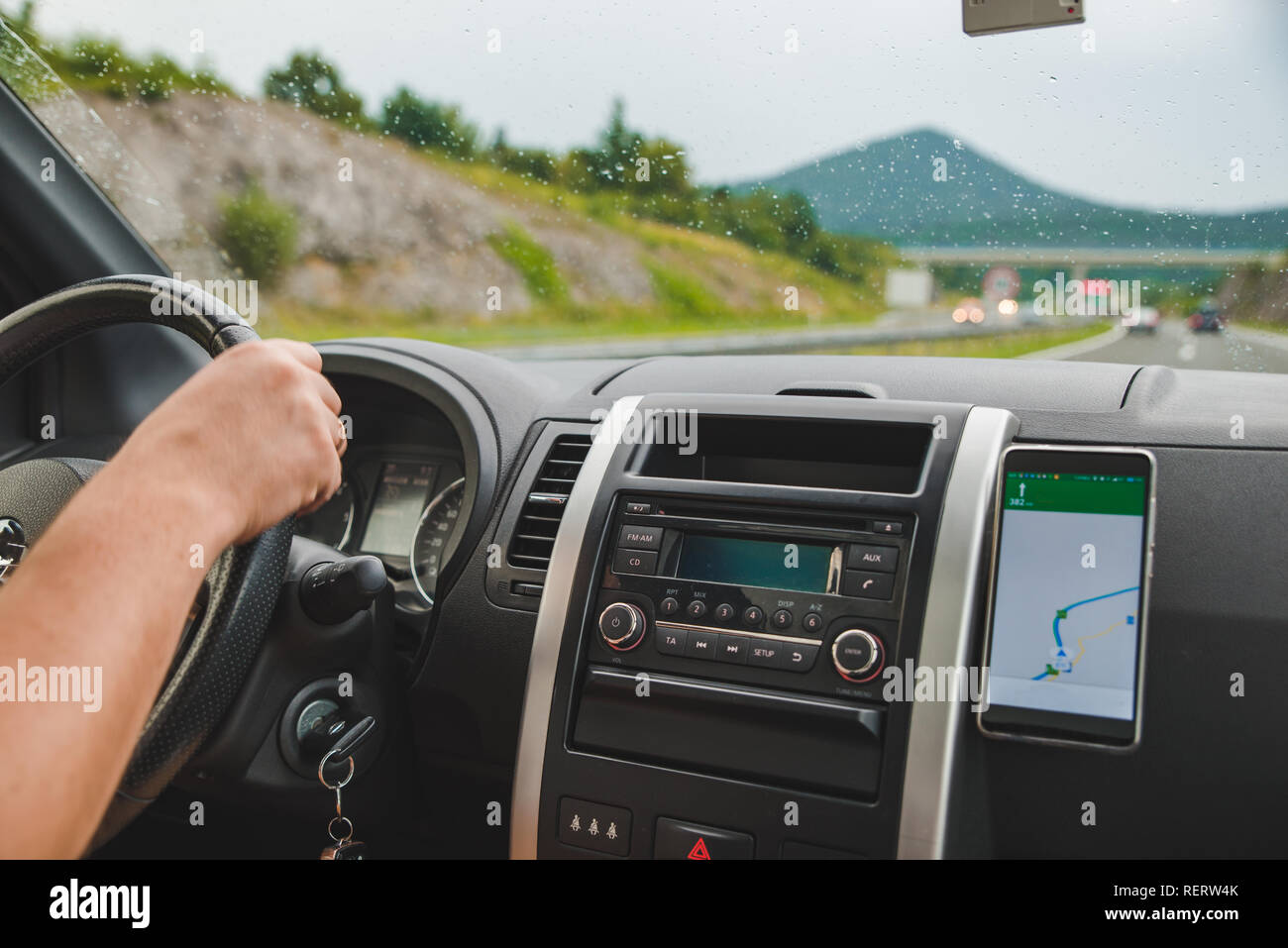 person driving car by speedway. navigation on the phone. travel concept ...