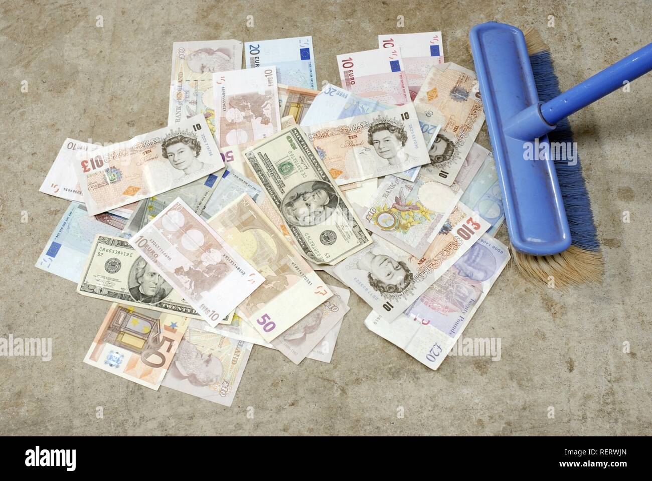 Bank notes being swept up with a broom Stock Photo - Alamy