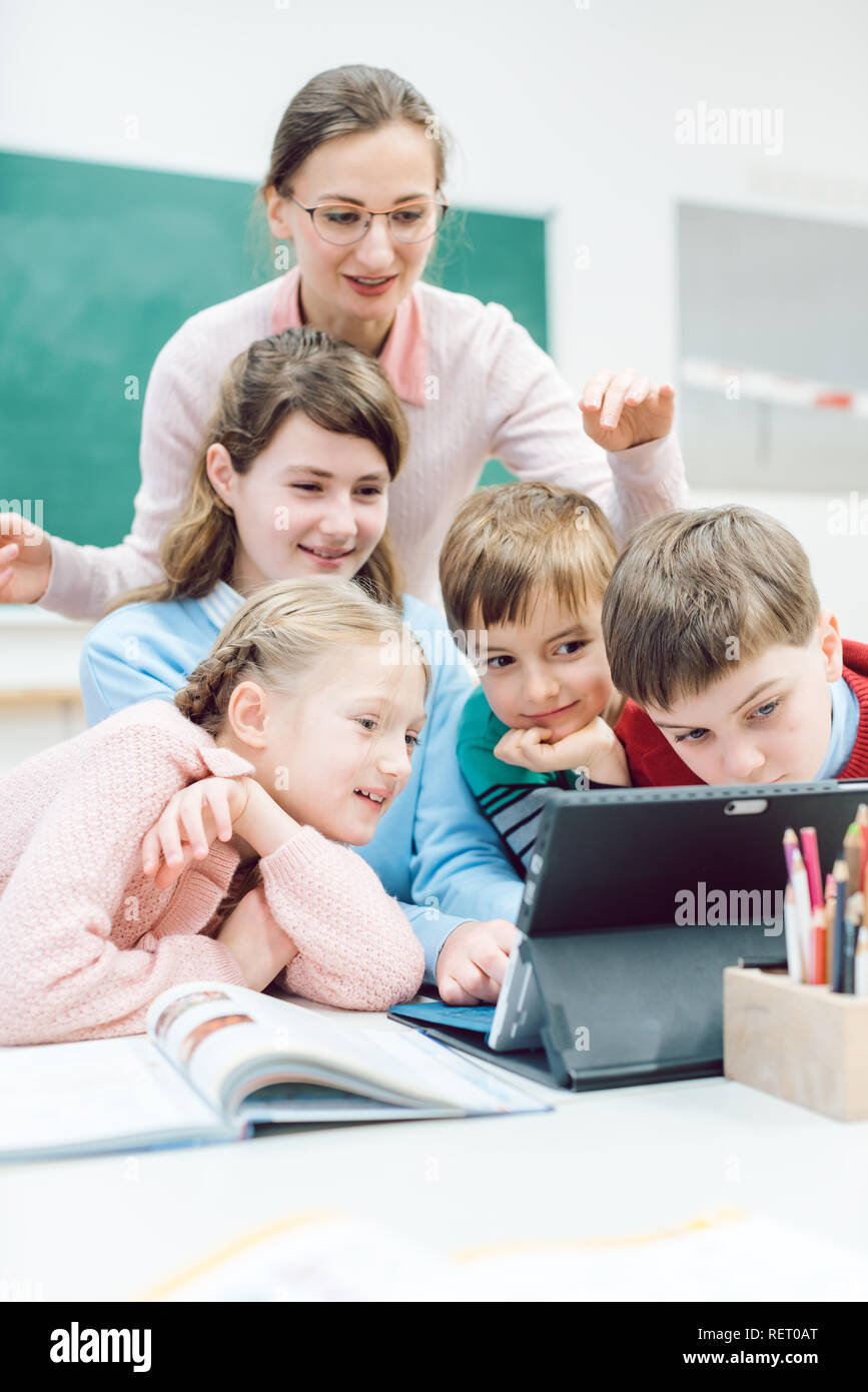 Teacher and students using media and technology in classroom Stock ...