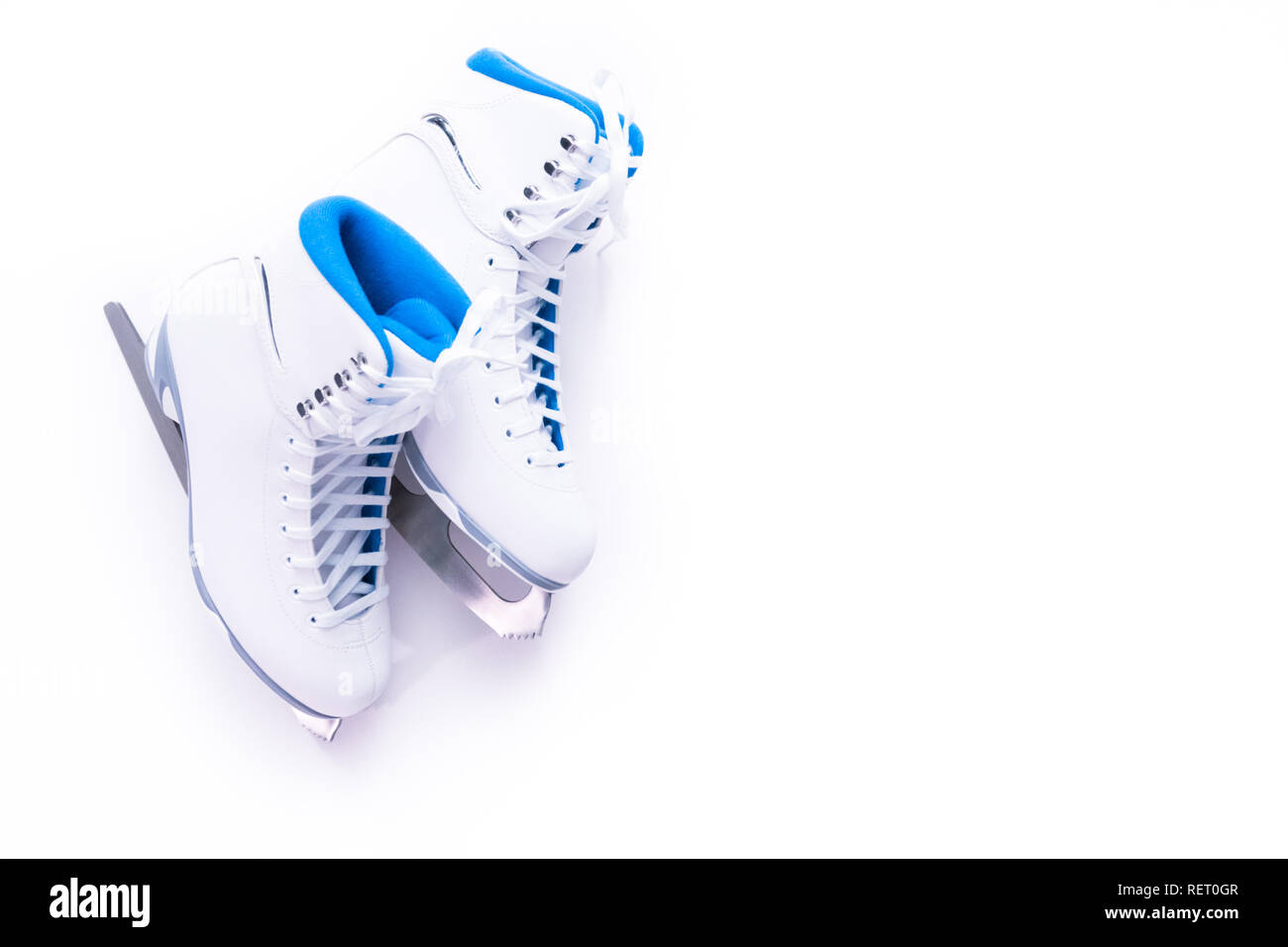 Flat lay. New white figure skates on a white background Stock Photo - Alamy