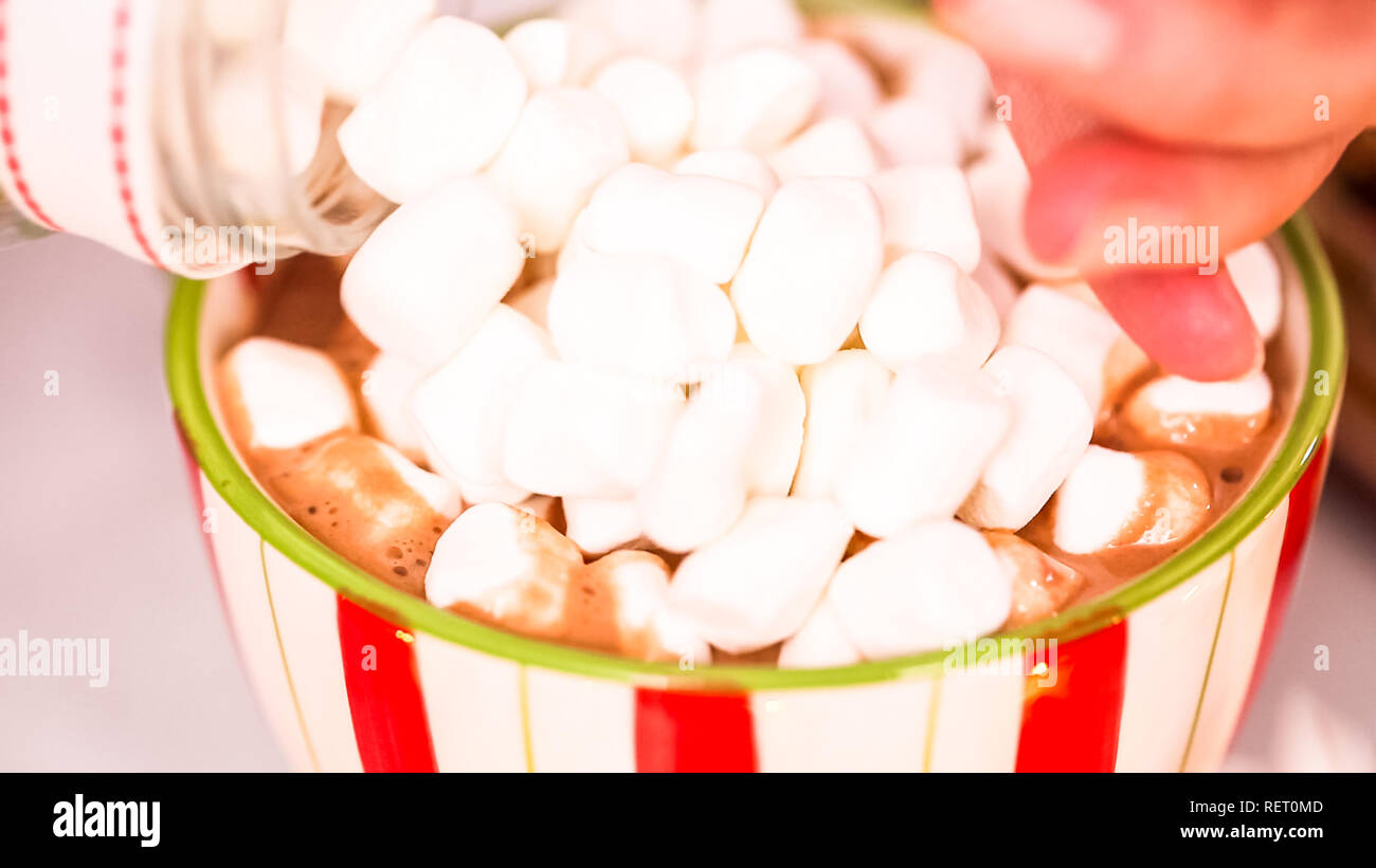 Garnishing American hot chocolate with marshmallow toppings Stock Photo ...