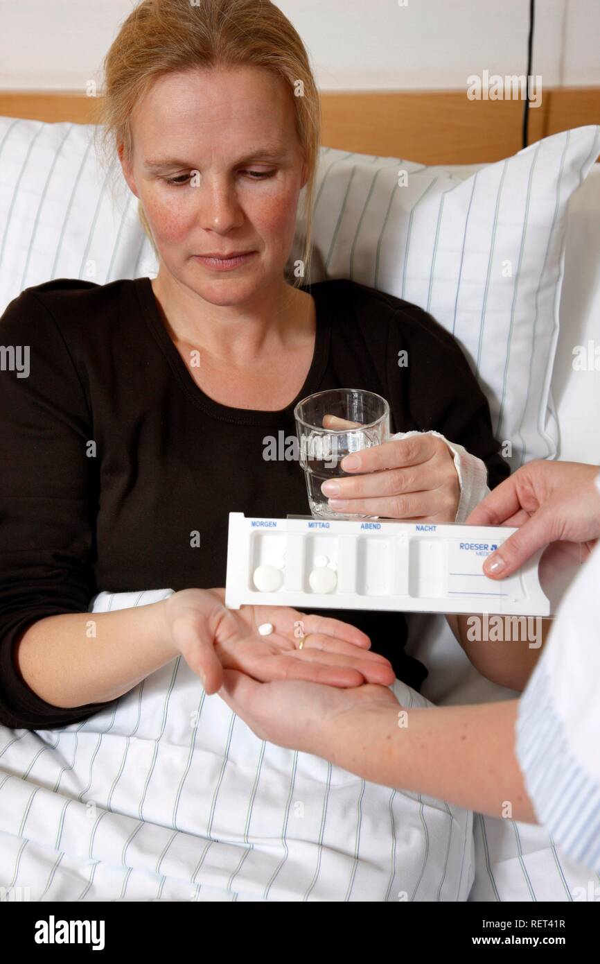 Patient getting medication while lying in a hospital bed Stock Photo ...