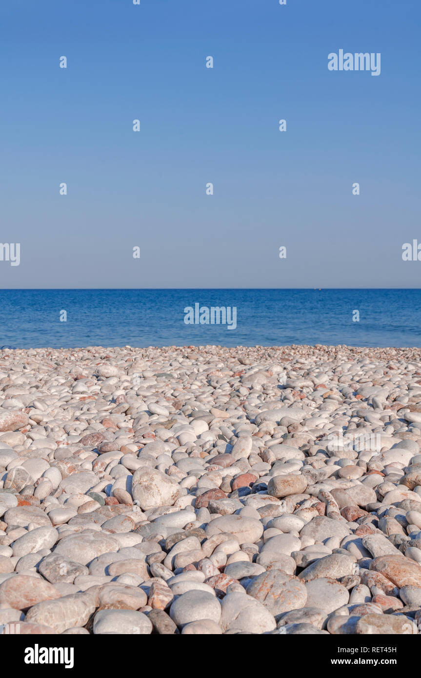 Pebble stony beach and blue wave sea with clean sky Stock Photo - Alamy
