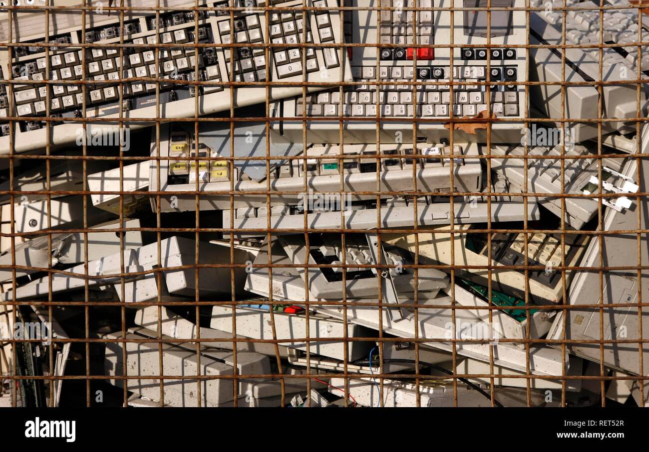 Electronic scrap, sorted used computer parts, keyboards, at a recycling ...