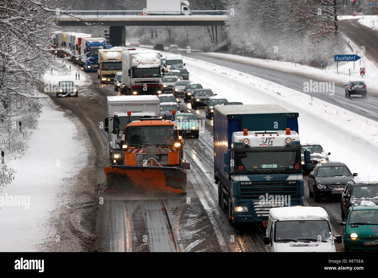 Snow plough in operation, traffic jam after heavy snow fall, motorway ...