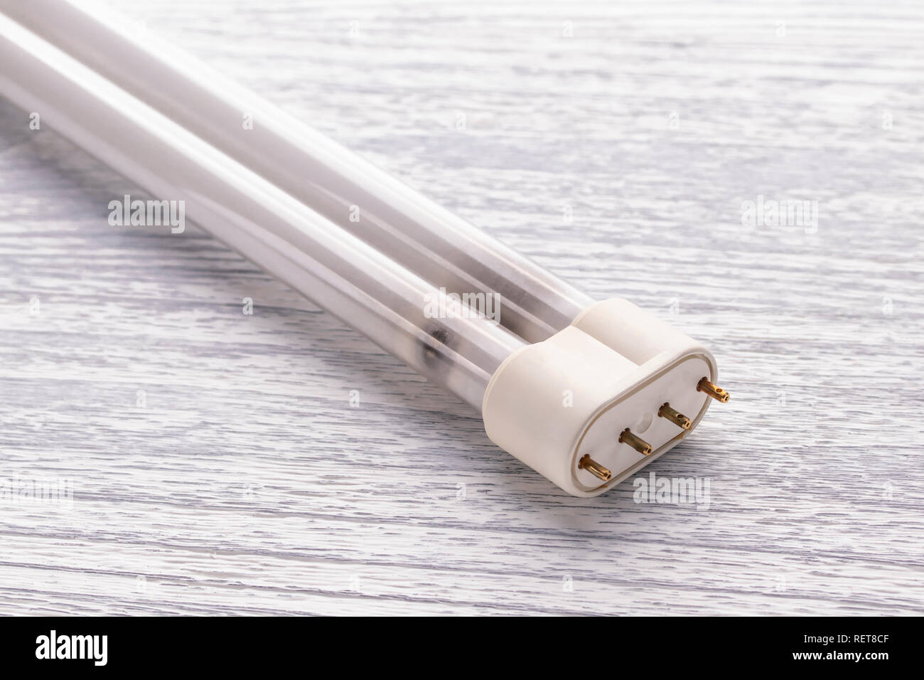 The contacts of the burnt fluorescent lamp PL-L, the black trail of ...