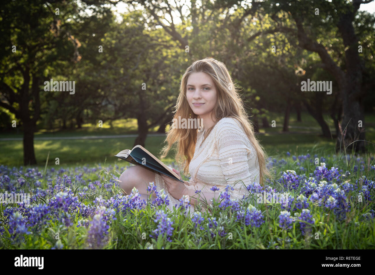 Girl Reading a book in bluebonnet flowers Stock Photo - Alamy