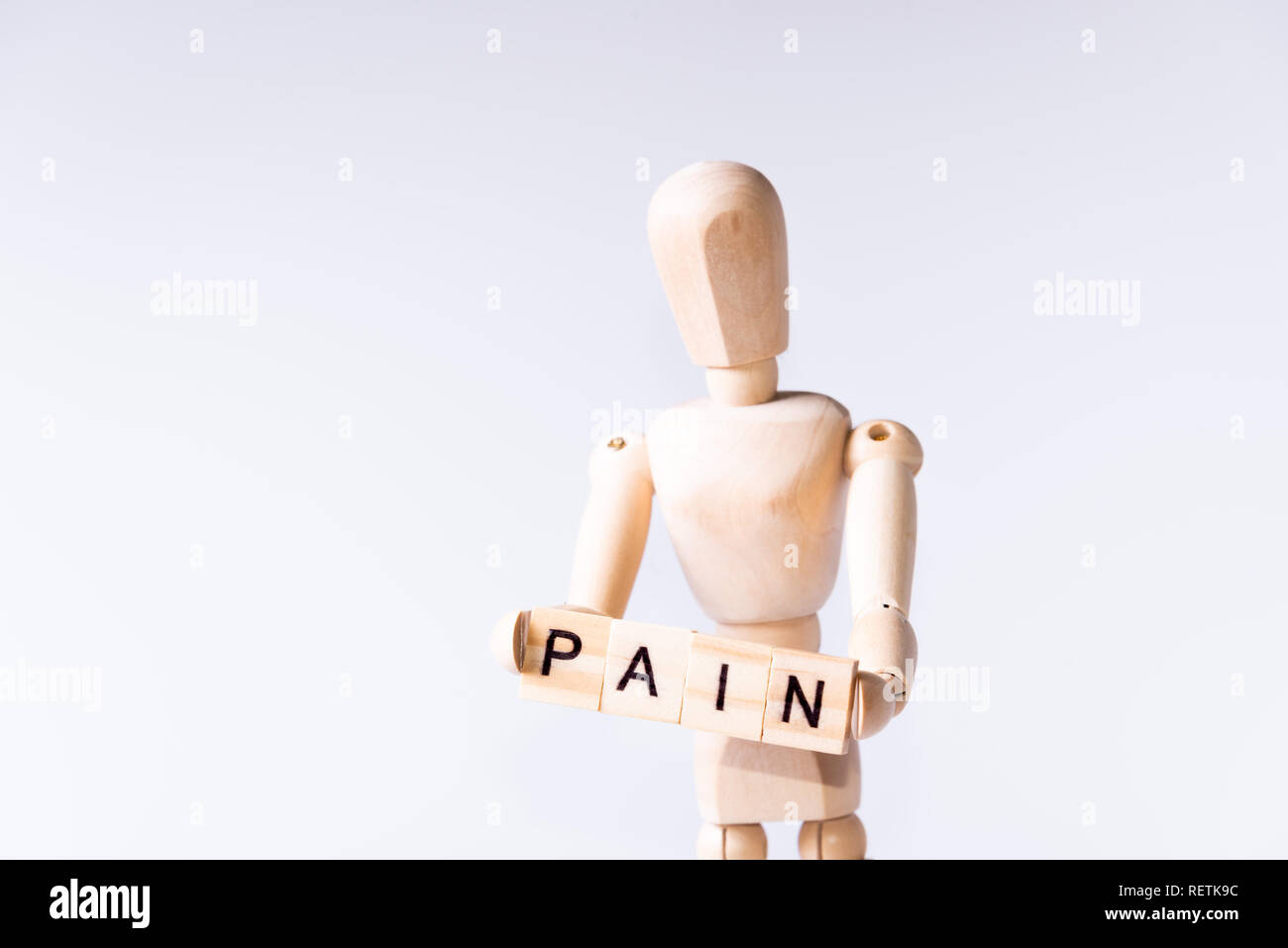 Wood man holding sign pain Stock Photo - Alamy