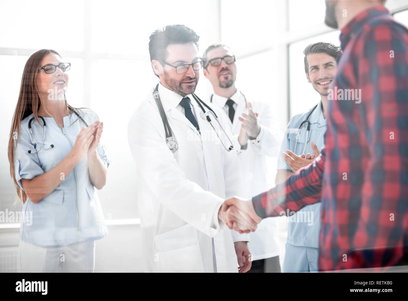 Thankful patient shaking doctors hand Stock Photo - Alamy