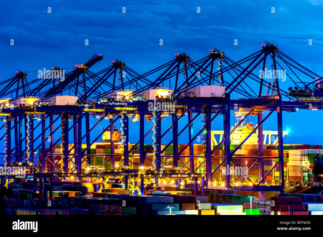 Container Cargo freight ship with working crane bridge in shipyard at ...