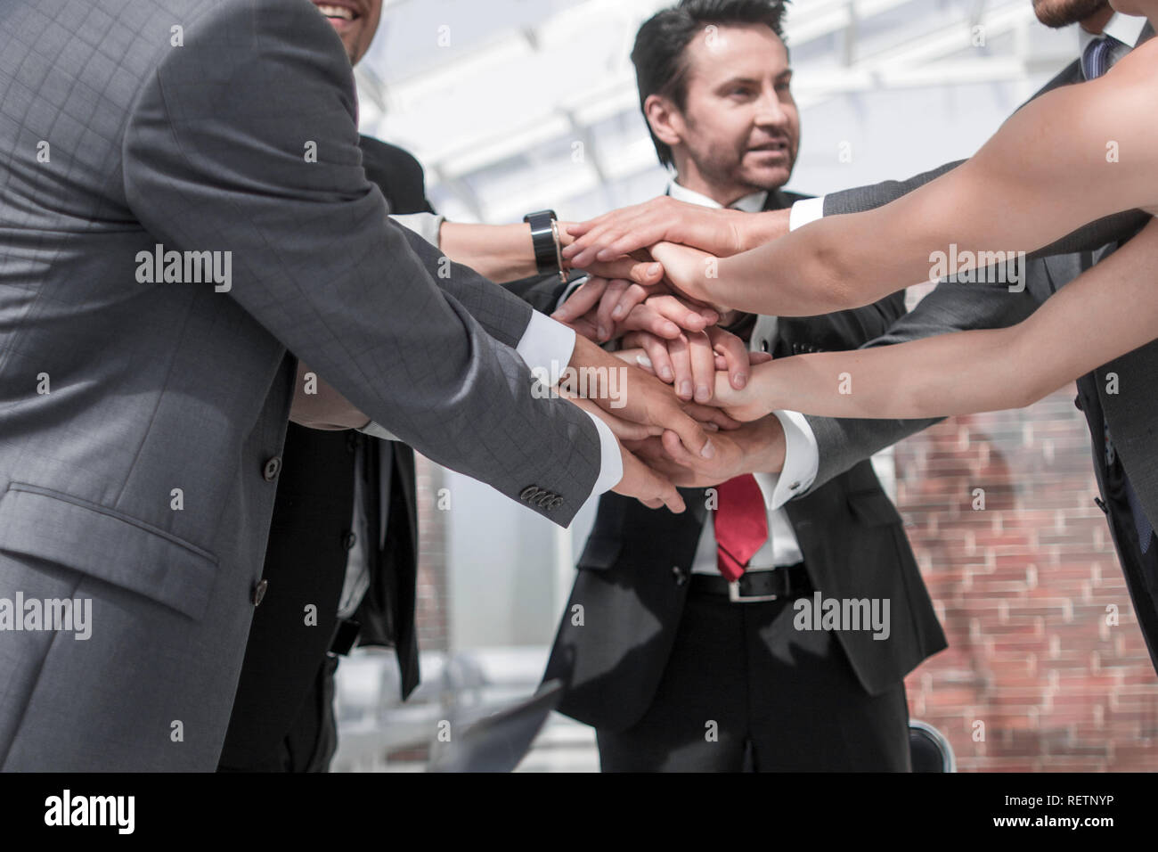 Business Team putting their hands together Stock Photo - Alamy