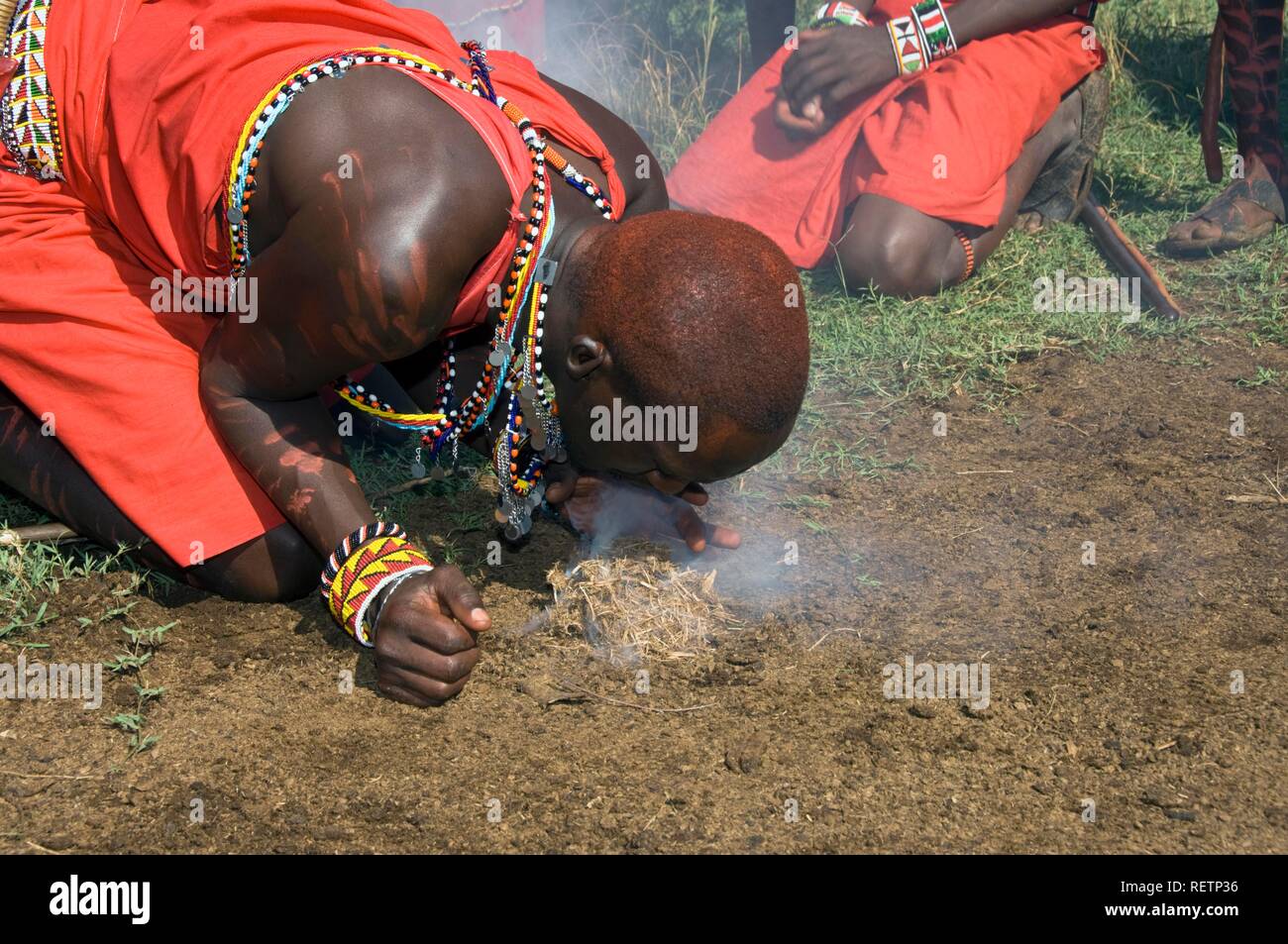 Masai man starting a fire with dried twigs, Masai Mara, Kenya, East ...