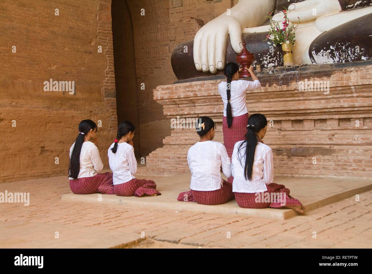 Burmese women praying to Buddha, Bagan, Myanmar Stock Photo - Alamy