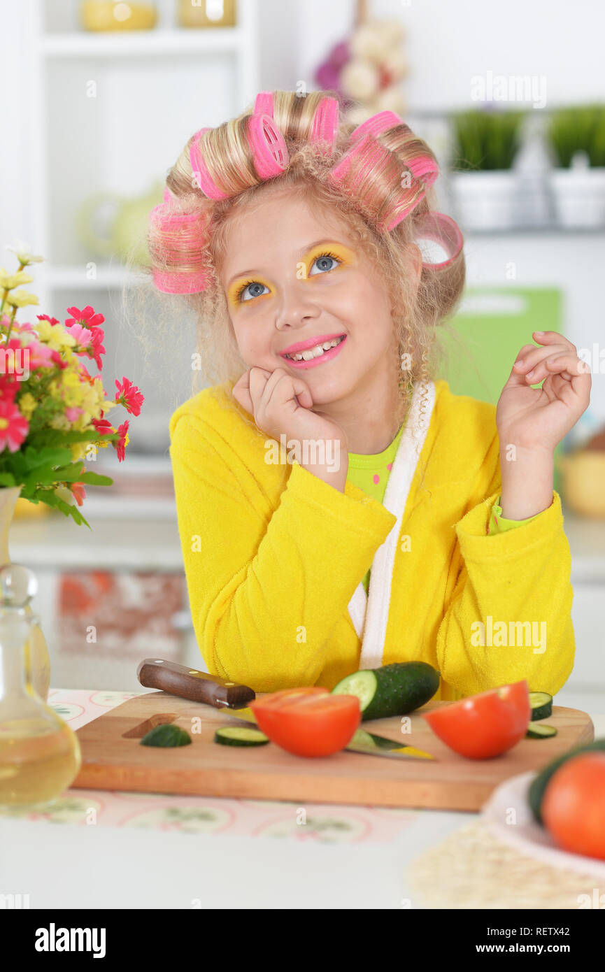 cute little girl with hair curlers cooking at kitchen Stock Photo - Alamy