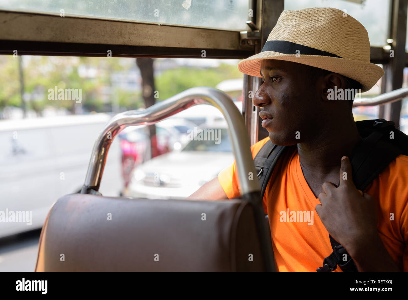 Profile view of young black African tourist man in bus Stock Photo - Alamy