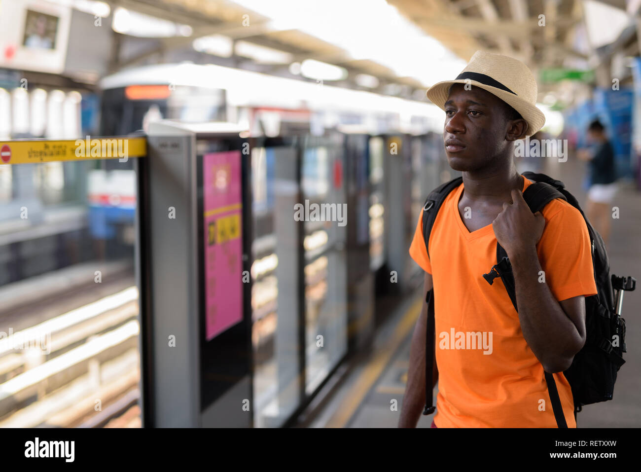 Young black African tourist man at train station Stock Photo - Alamy