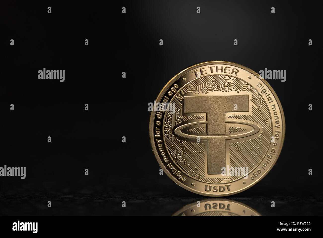 Tether USDT cryptocurrency physical coin placed on the reflective ...