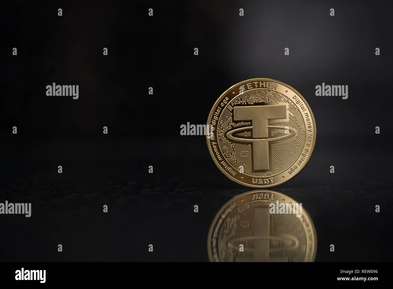 Tether USDT cryptocurrency physical coin placed on the reflective ...