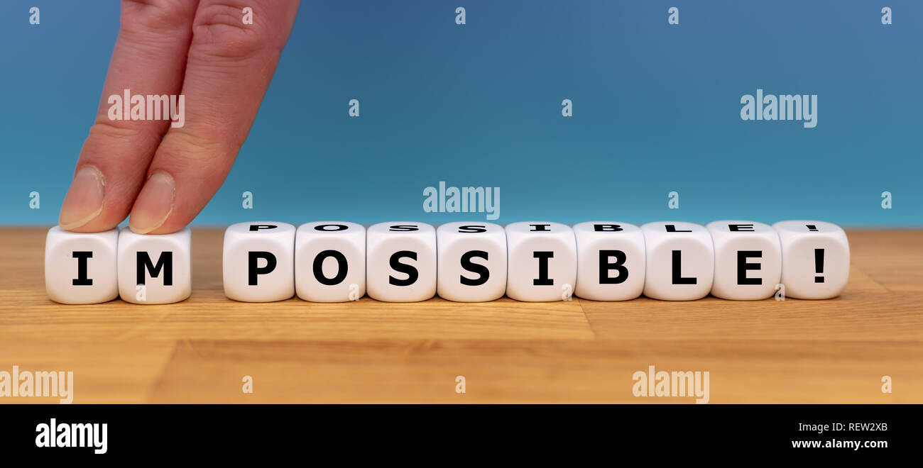 Dice form the word "IMPOSSIBLE" while two fingers push the letters "IM ...