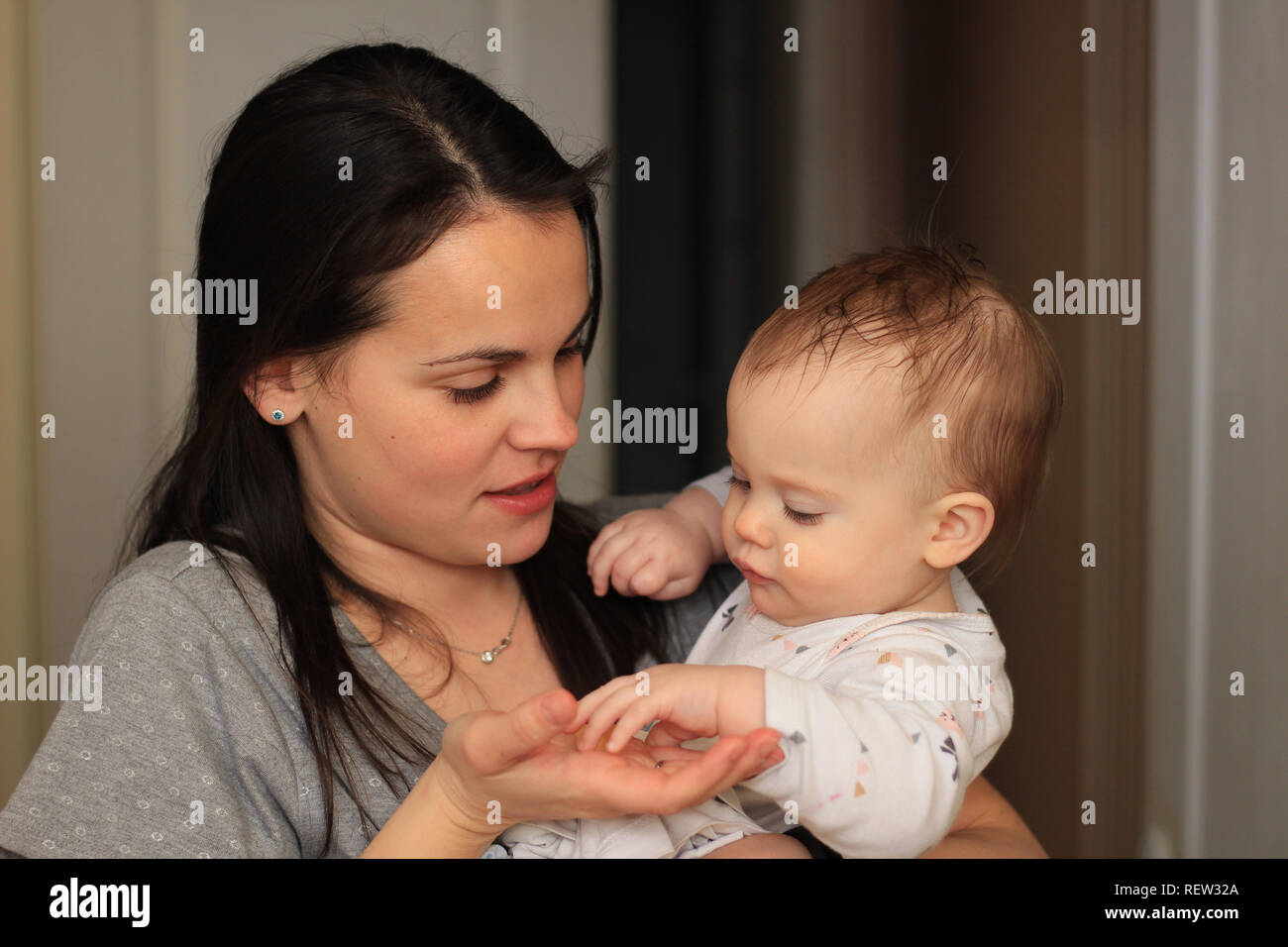 smiling beautiful mother with her baby Stock Photo - Alamy