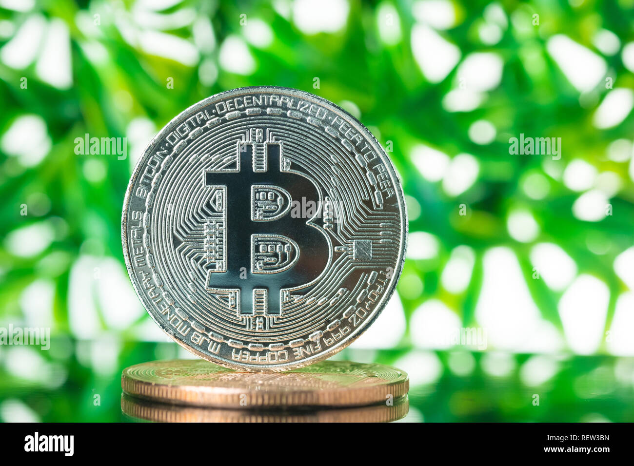 Bitcoin digital currency, bit-coin on green blurred bokeh background ...