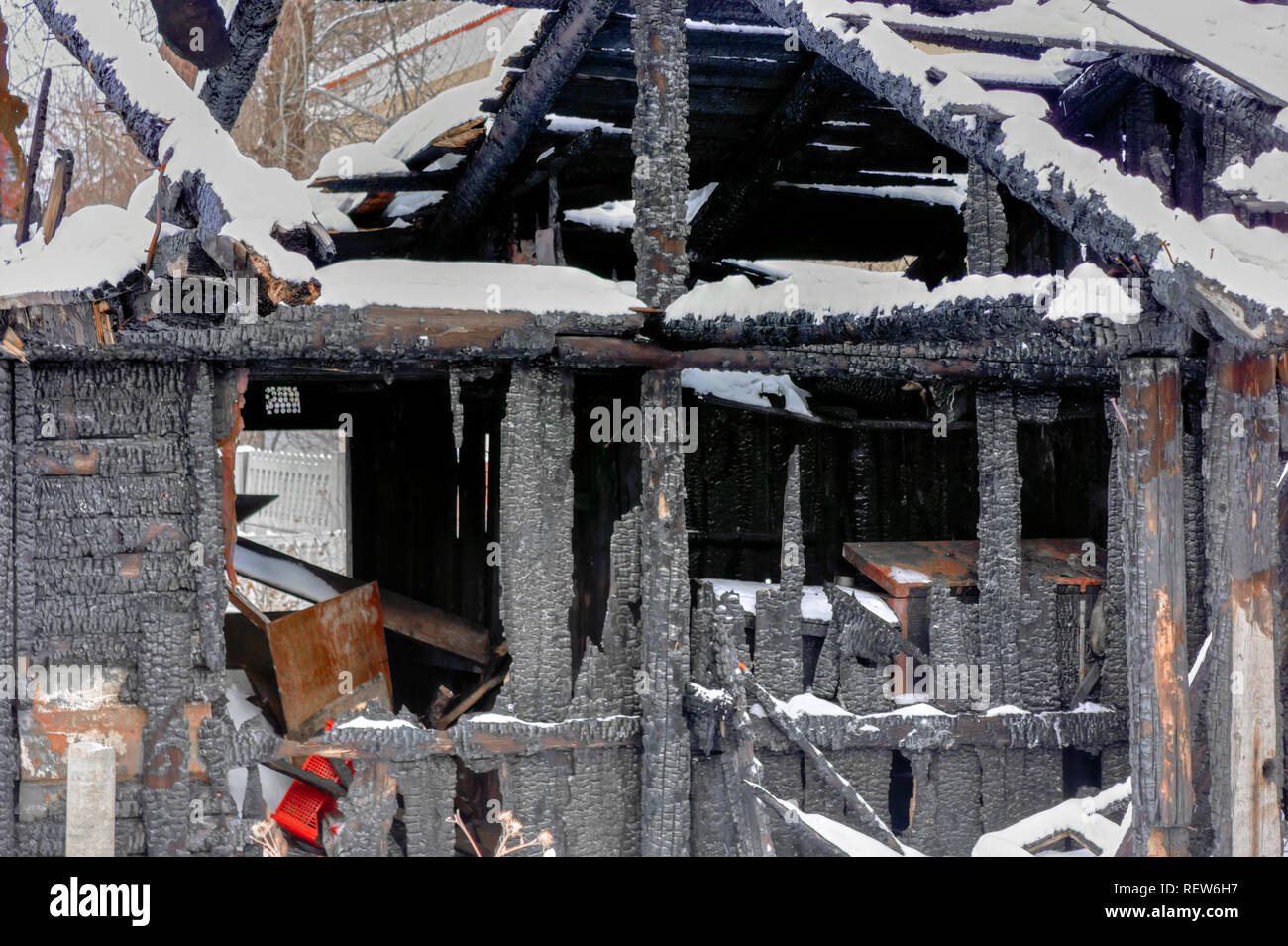 The facade of an wooden house damaged by a fire. The burnt section of ...