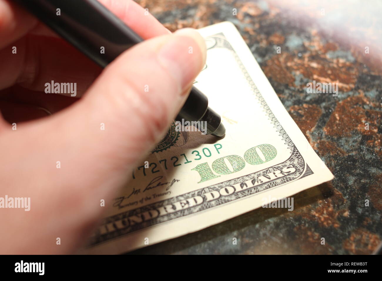 Counterfeit money testing pen Stock Photo - Alamy